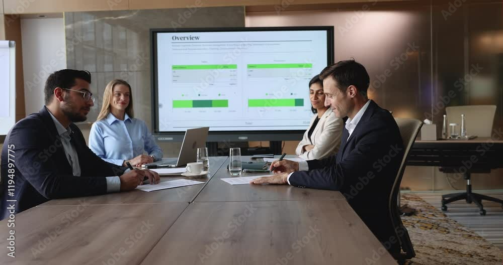 Two parties represented by business professionals reviewing, signing ...