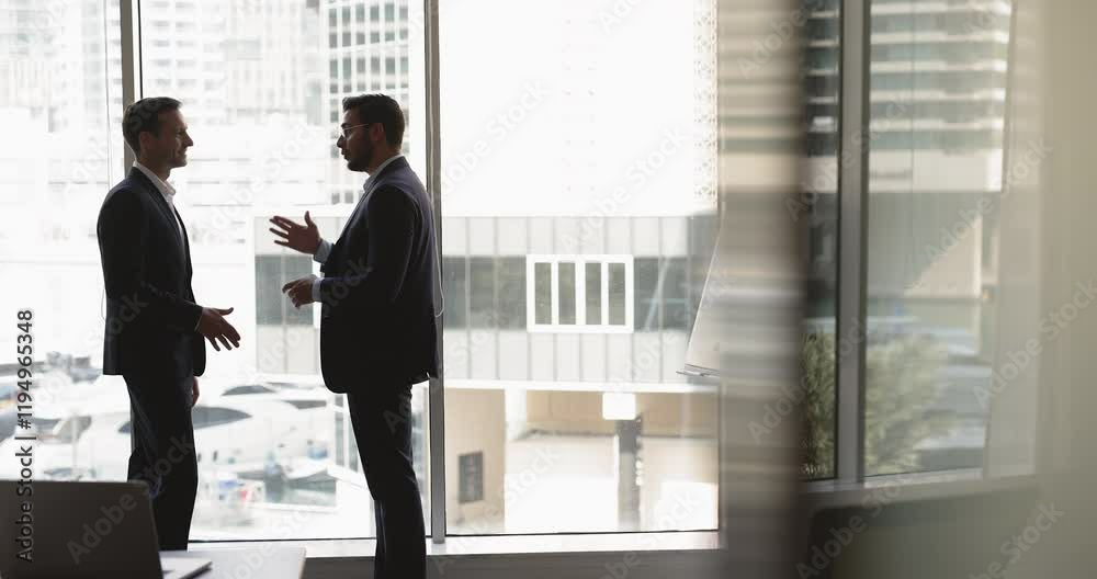 Hispanic and Arabian men colleagues talking standing against panoramic ...