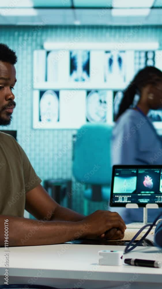 Vertical video Black medic measuring the blood pressure and pulse of a ...