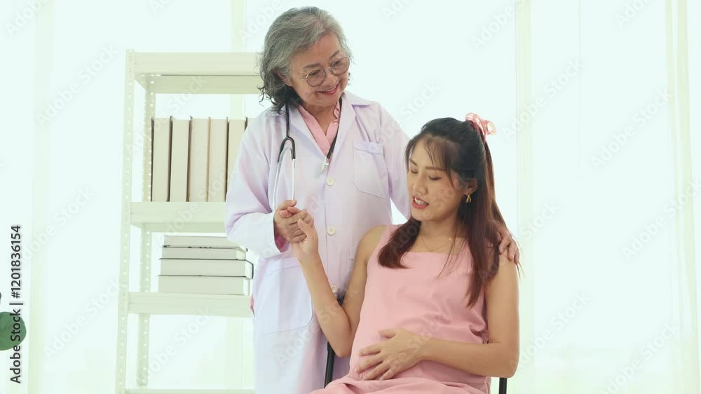 Senior doctor uses stethoscope to check fetus' health, measure fetal ...