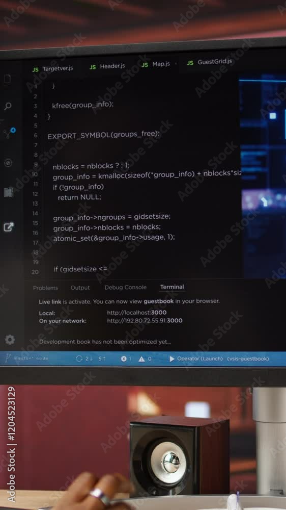 Vertical video IT engineer drinking coffee, using computer at home for ...
