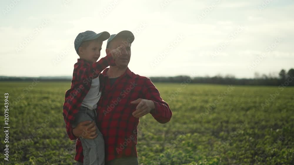 Farmer family in field. Father holding child learning about agriculture ...