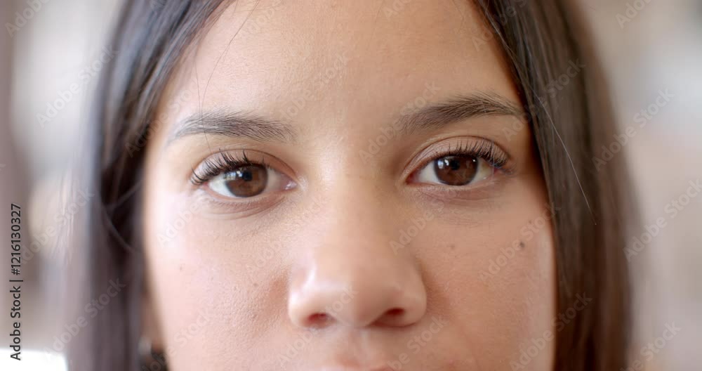 Biracial young woman with brown eyes looking forward at home Stock ...