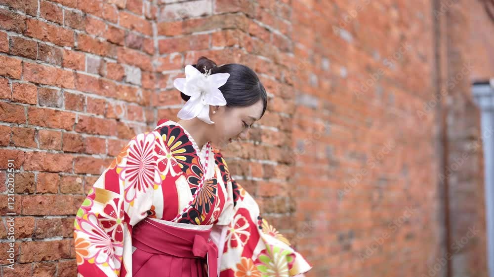 A young woman in her 20s wears a traditional graduation ceremony Hakama ...