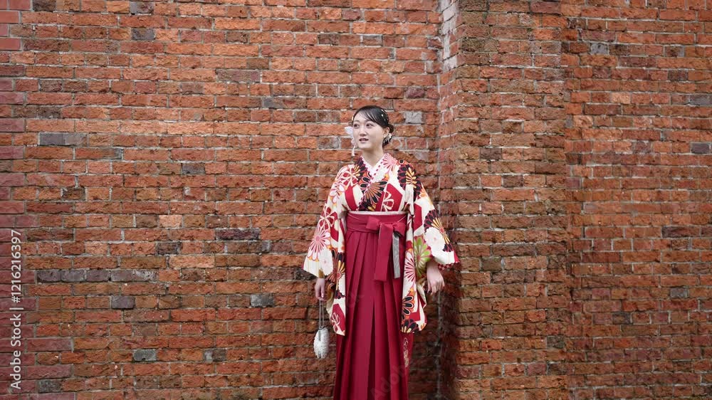 A young woman in her 20s wears a traditional graduation ceremony Hakama ...