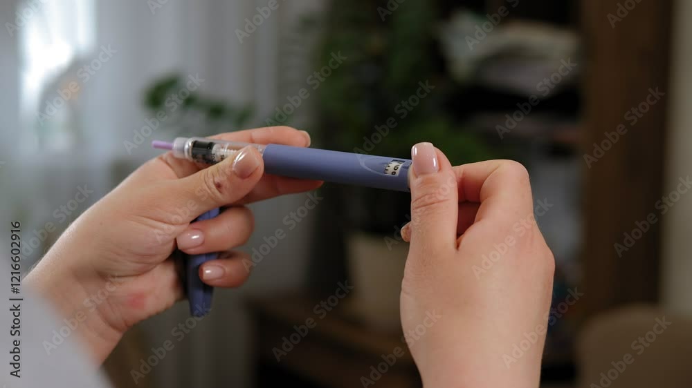 Close-up of an unrecognizable diabetic woman dialing the correct dose ...
