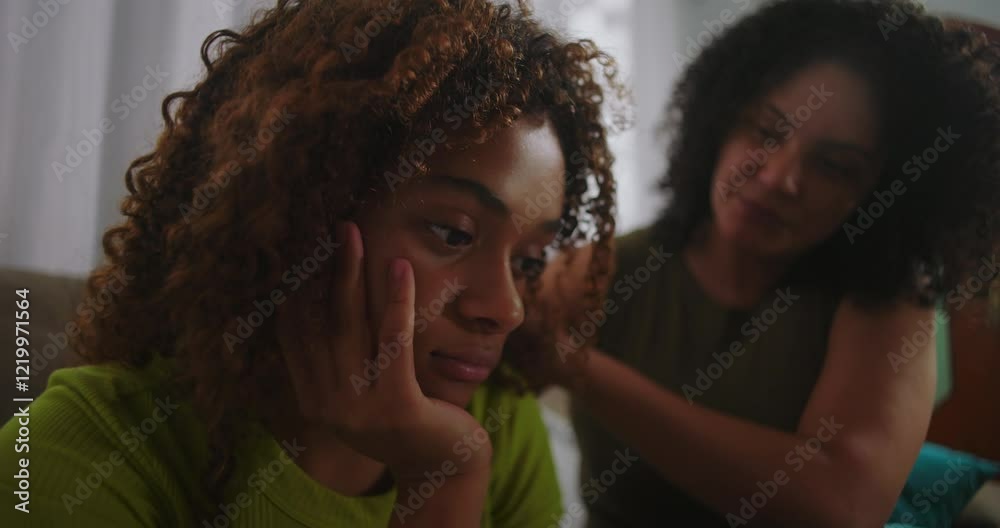 Teenage daughter feeling sad and reflective while mother provides ...