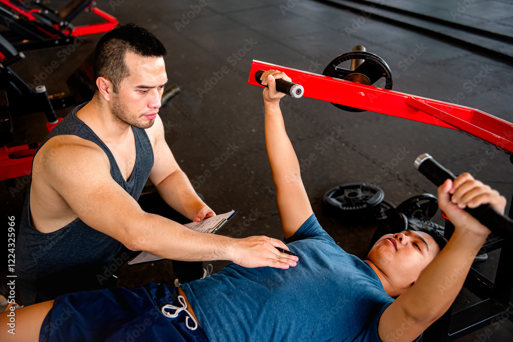 Photo & Art Print A male trainer checks the trainee's chest exercises ...