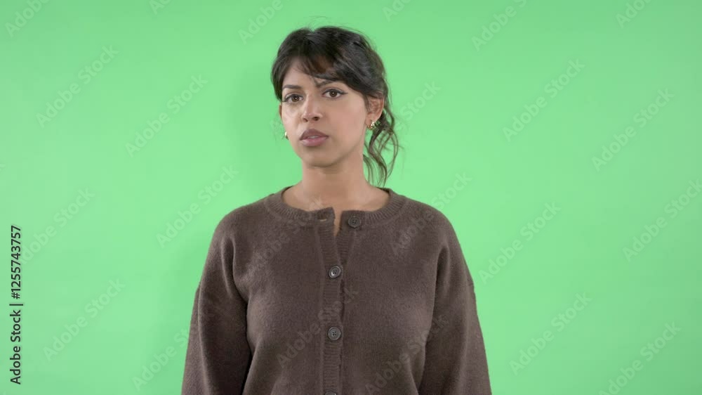 Confident woman showing strong pose shaking head side to side in ...