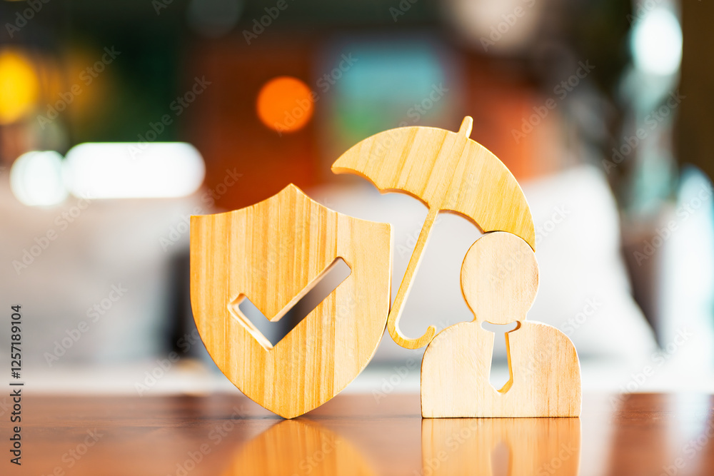 Poster A wooden model of a businessman and an umbrella on a table is a ...