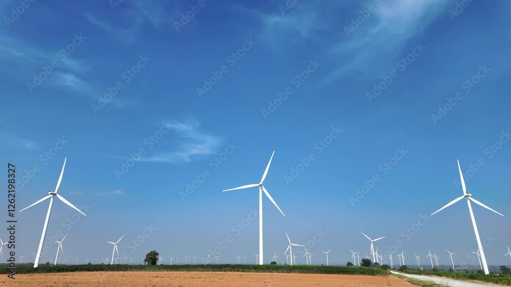 Vidéo Stock Vast wind farm with multiple turbines spinning under a ...