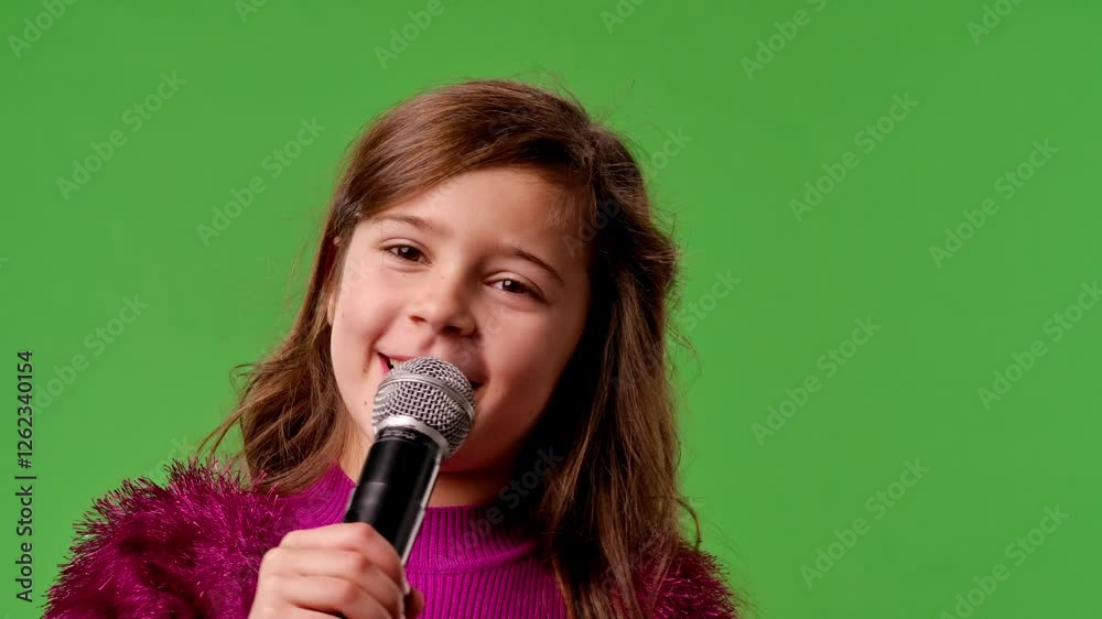 Smiling girl child singing song in karaoke microphone, positive ...