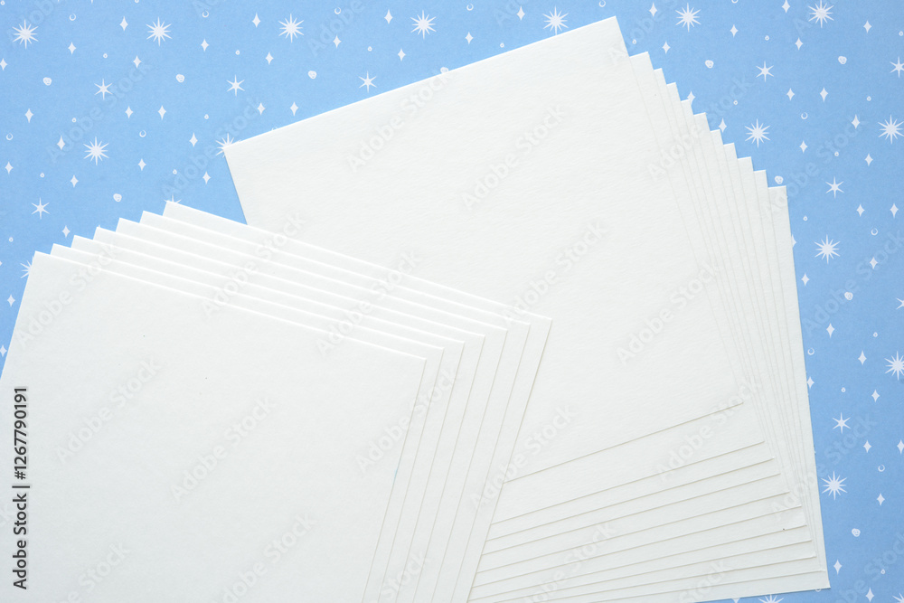 Poster two staggered piles of blank note cards overlapping on blue ...