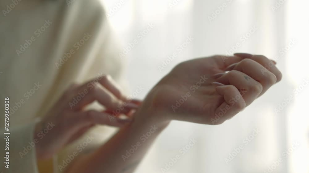 A girl with long nails scratches her hand. The girl scratches her palm ...