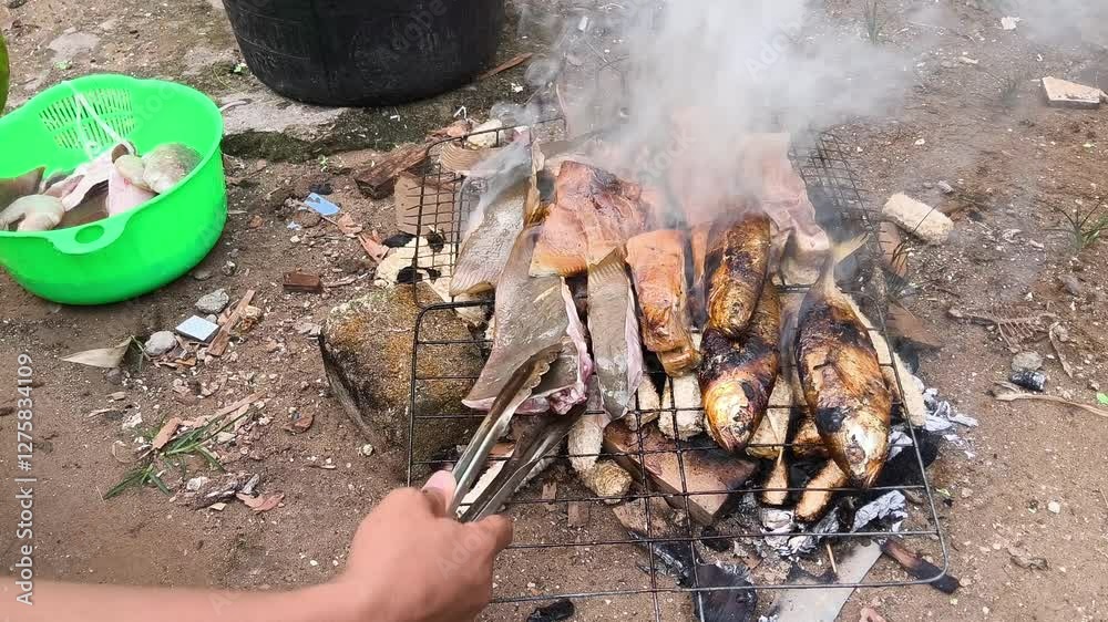 Burn stingrays and pelagic fish outdoors on the ground with coconut ...
