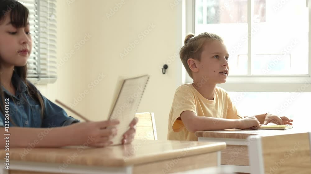 Smart student answer teacher's question while sitting at classroom ...