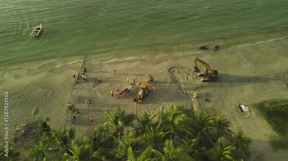 Laying fiber optic cable on a beach in Isla de Margarita, teamwork and ...