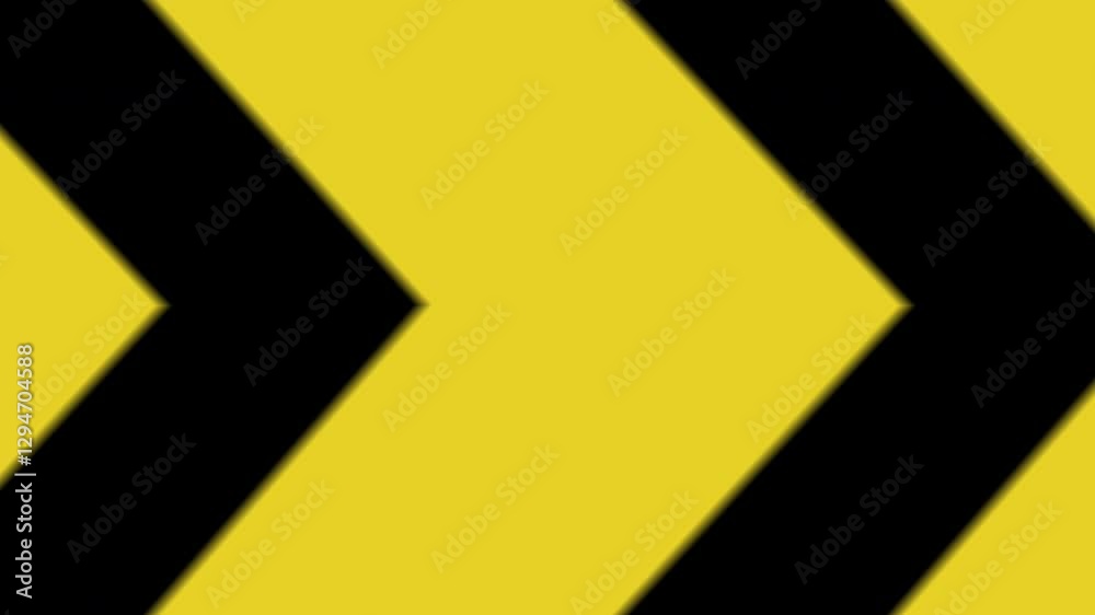 Yellow and black hazard warning arrow markings moving left to right on ...