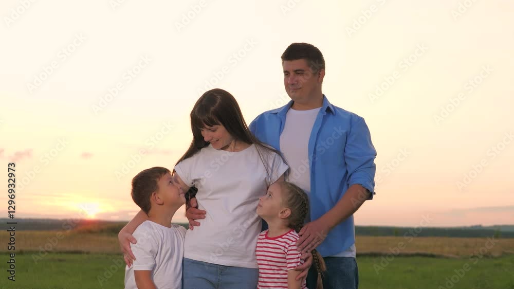Happy family hugging posing together at sunset field sky nature ...