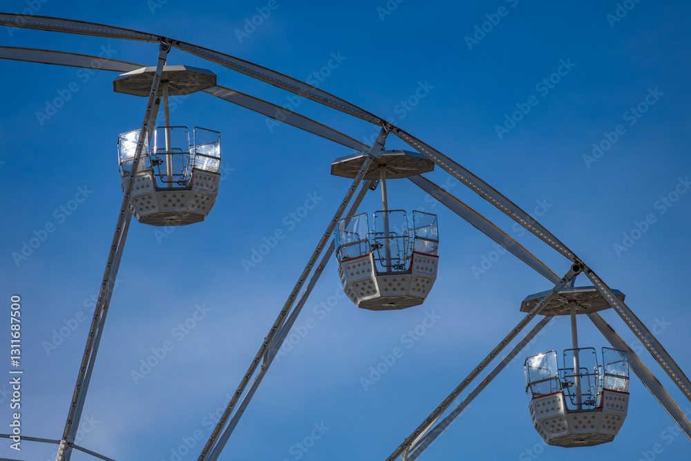 Poster A tall carousel with a mill wheel and white carriages set in the ...