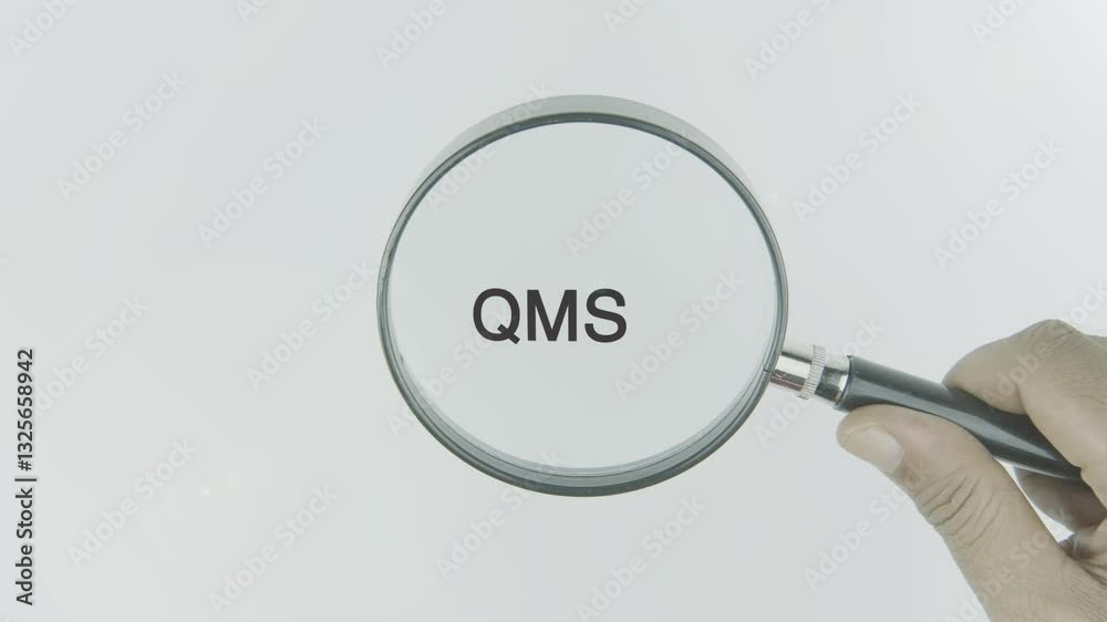QMS (Quality Management System) highlighted by a magnifying glass on a ...