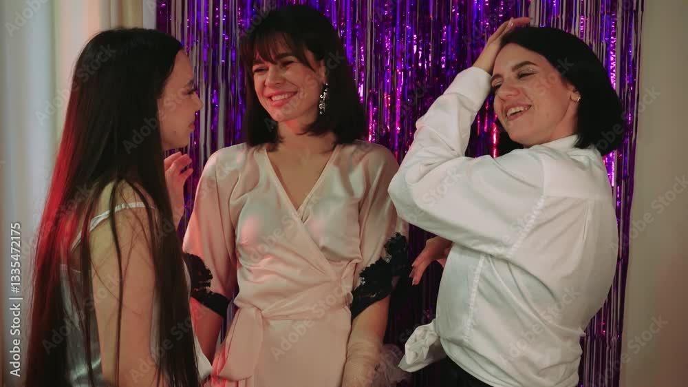 Women in white clothes are dancing and having fun in front of purple ...