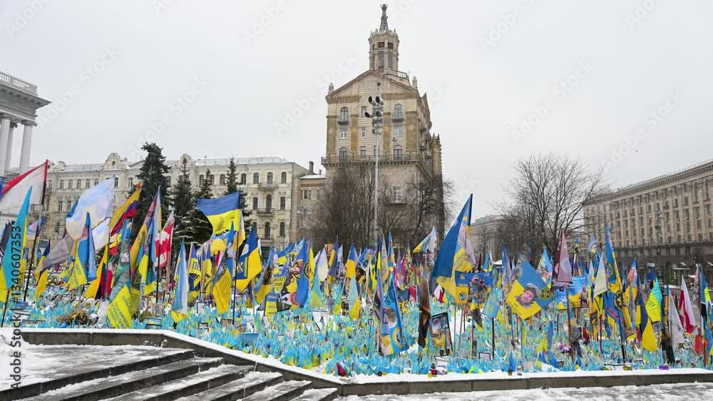 Ukrainian and international flags line a war memorial in Kyiv’s ...