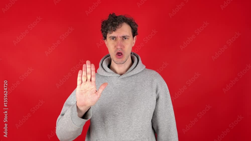man raises hand, palm forward, showing in front sign stop, ban ...