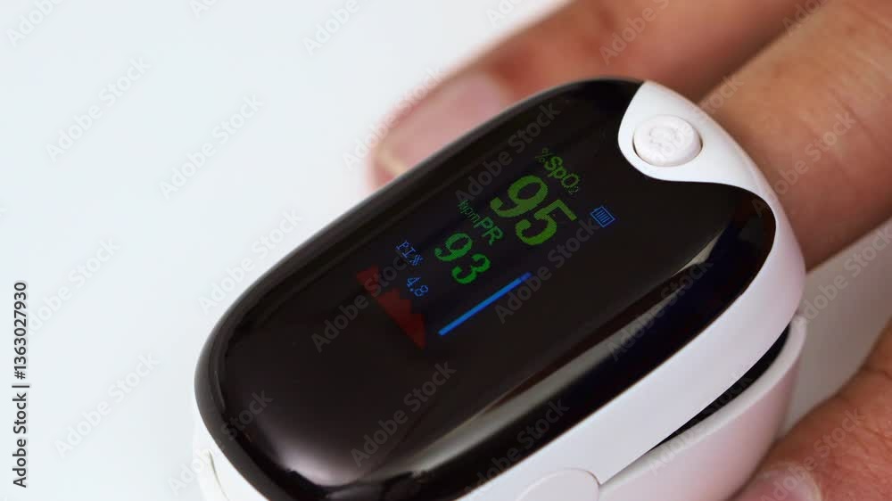 Pulse Oximeter Reading: A close-up shot of a finger inserted in a pulse ...