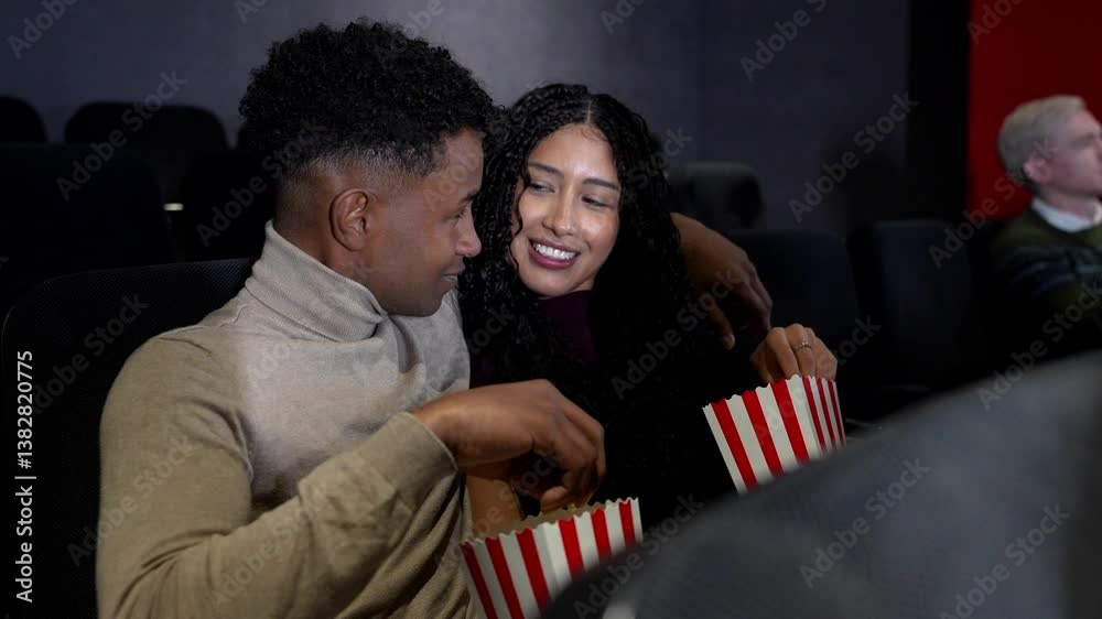 Young couple sharing popcorn and laughter at the cinema Stock Video ...