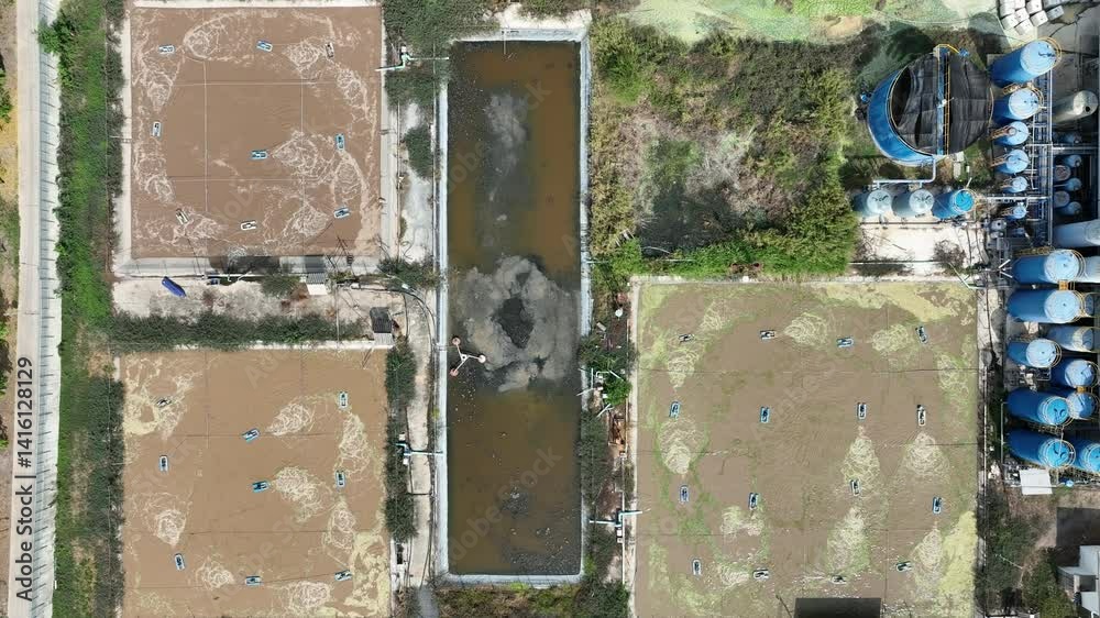Top-down view reveals a layout of rectangular brown aeration ponds with ...