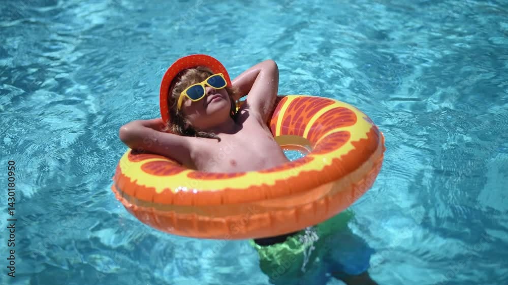 Swimming pool fun with happy kid. Kid splash in pool on summer day ...