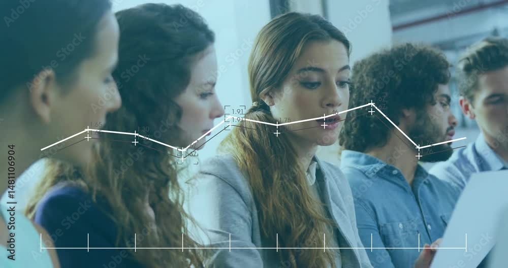 Coworkers reviewing business data sheets in conference room, showing ...