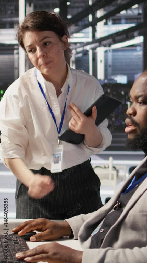 Vertical video Lead data center admin overseeing IT expert integrating AI in equipment rigs ...