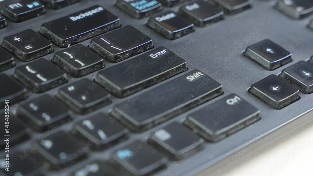Close-up of a black keyboard featuring the Enter, Shift, and Ctrl keys ...