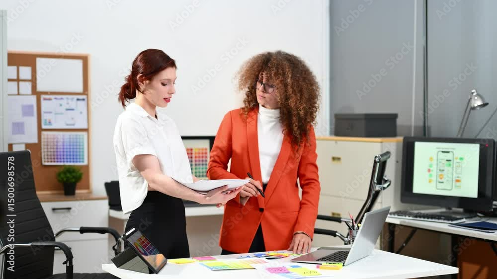 Creative women designers working on mobile app UX UI with color ...