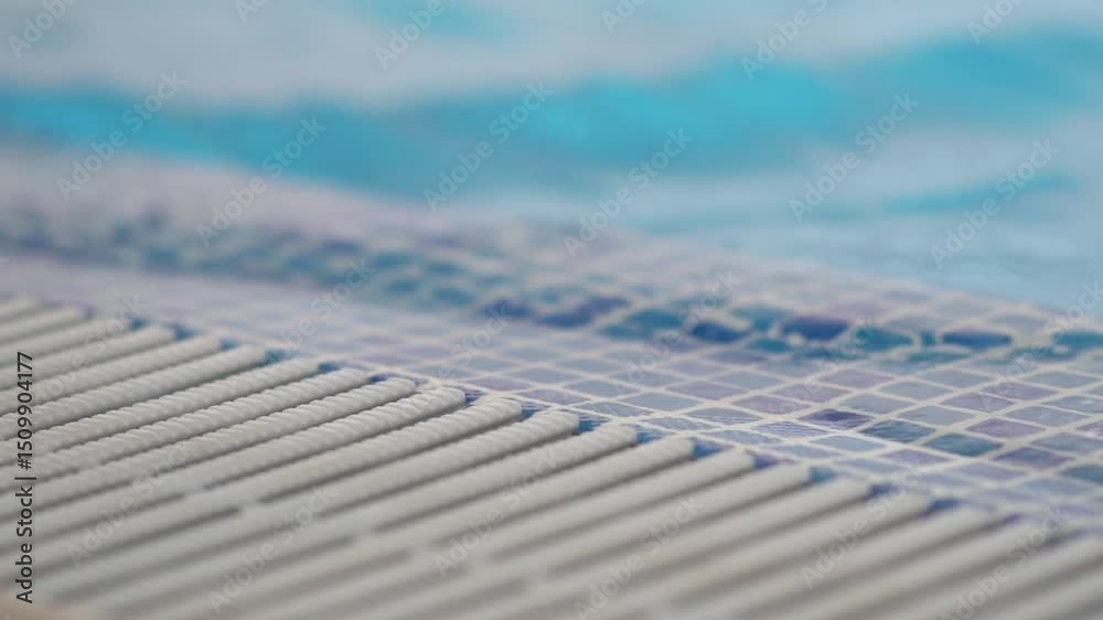 pool overflow grate. Swimming pool water pouring into the overflow grid ...