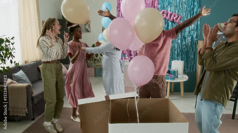 Full shot of African American husband slowly lifting lid on cardboard ...