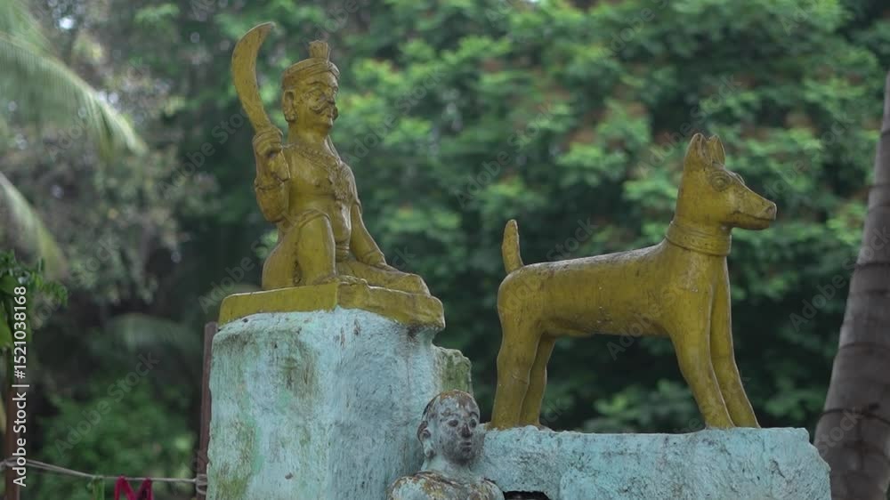 A sacred village shrine under a large tree featuring yellow statues of ...