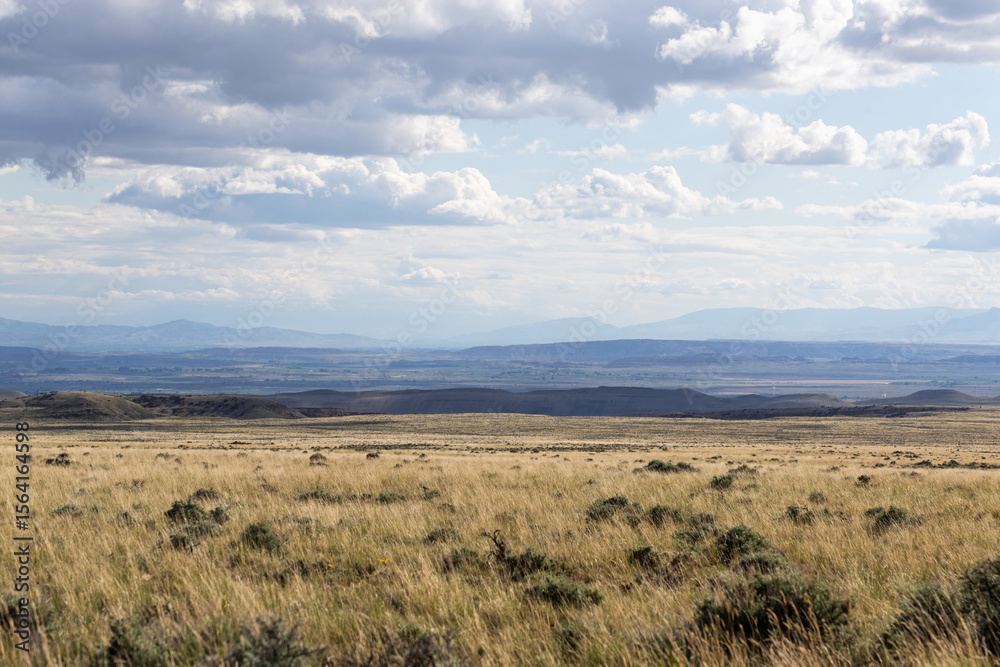 Poster Scenic vista showing grassy prairie with layers of mountains and ...
