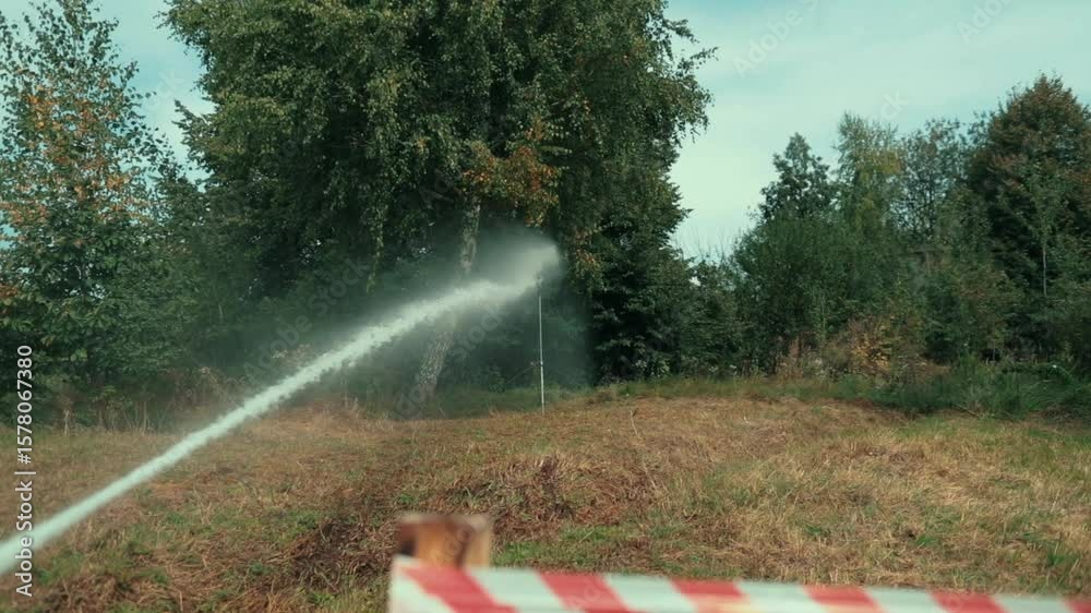 Firefighters participate in training, skillfully aiming a powerful ...