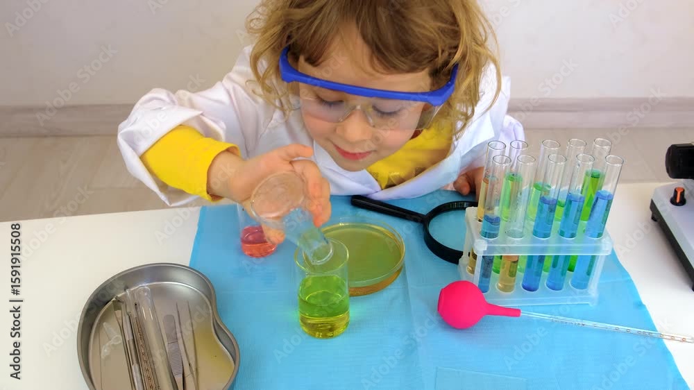 Laboratory examination of a child with test tubes, reagents and a ...