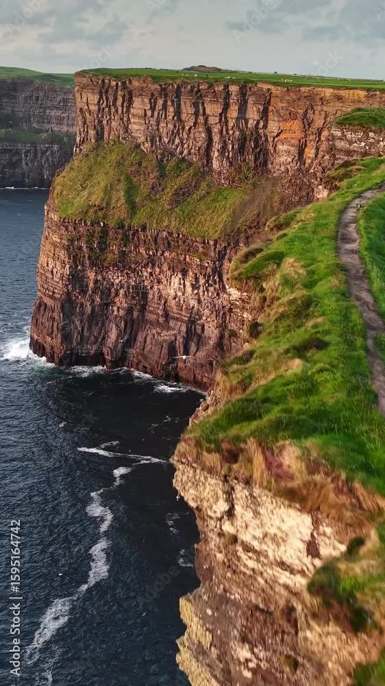 Aerial vertical coastal views along Cliffs of Moher in Ireland ...