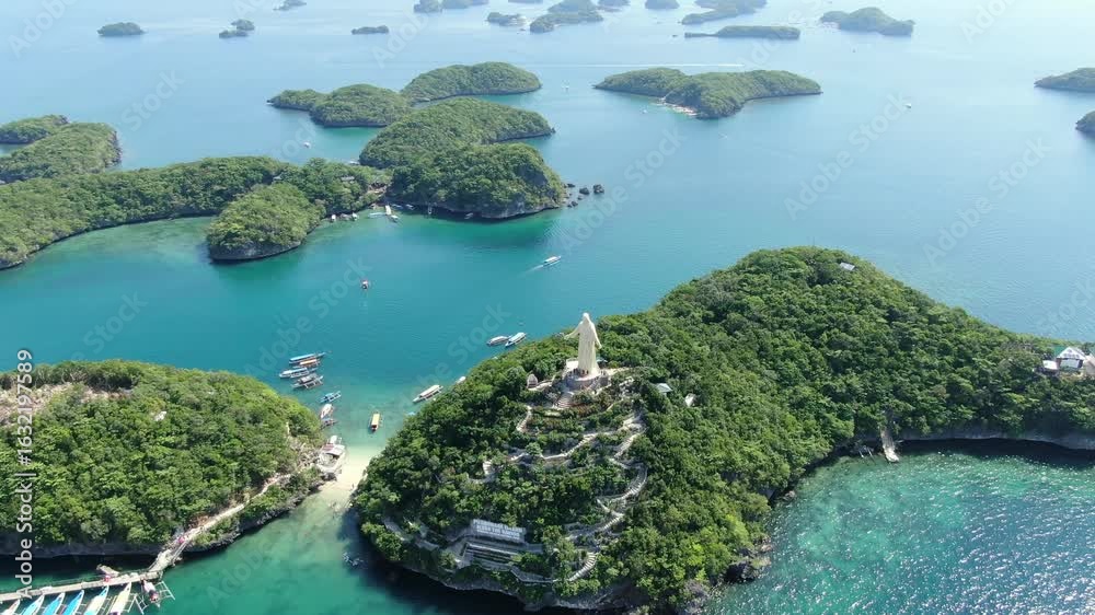 Drone clip of the statue of Jesus Christ on top of pilgrimage island in ...