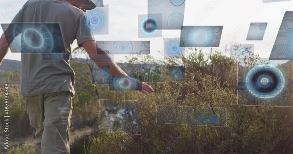 man walking along path activating tech panels and sweeping hand using ...