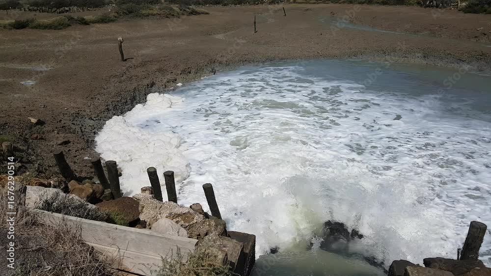 Torrents of water rush through floodgates in the Carboneros marshes ...