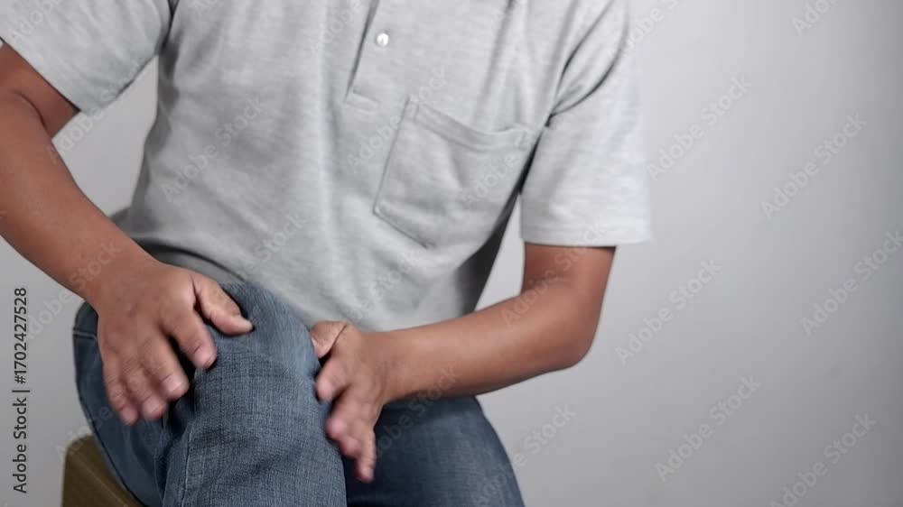 Man with knee pain, he puts his hand on his knee, pain point from ...