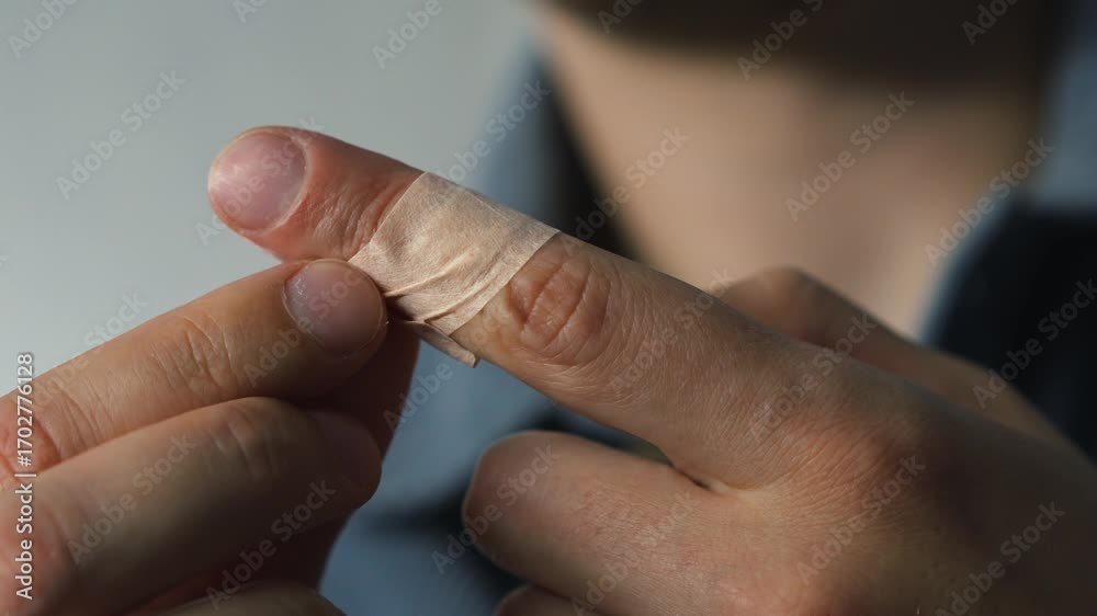 Protective medical tape on an injured finger. Adhesive tape to protect ...