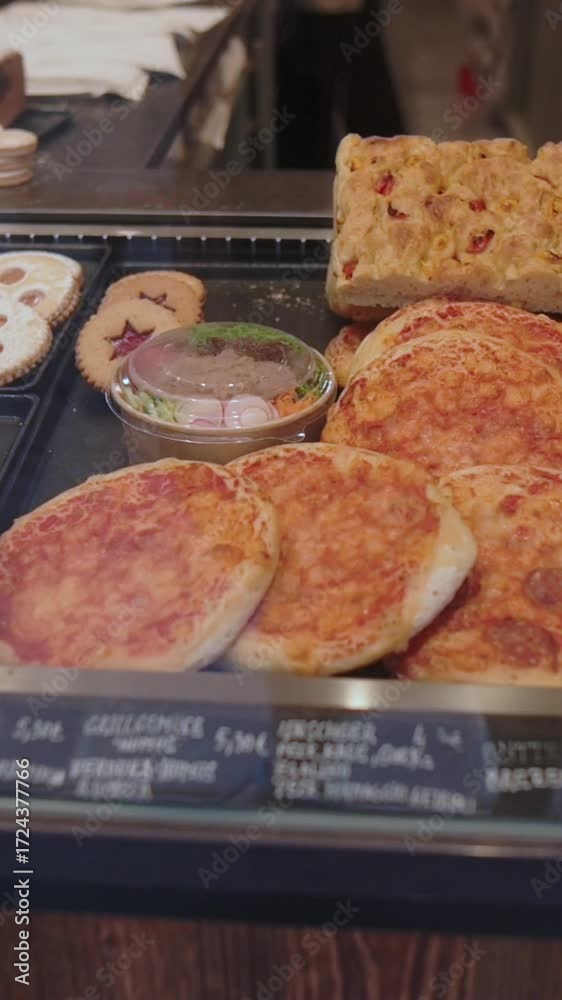 Vertical screen of bakery display with Italian pizza bread and savory ...