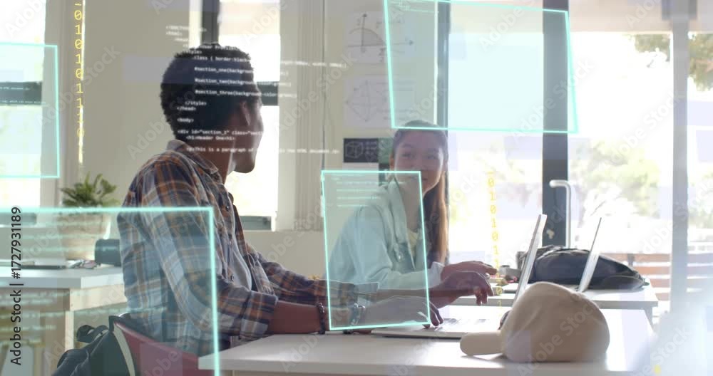 Vidéo Stock teacher gesturing to laptop in tech lab initiating code overlays as students ...